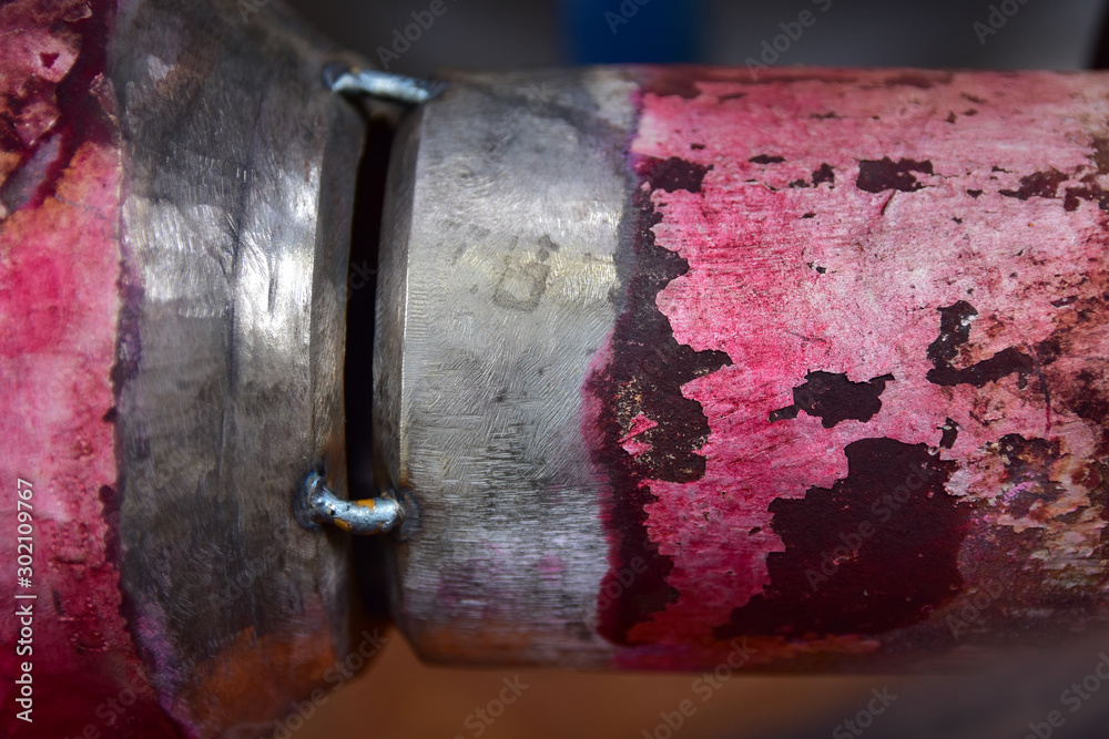 Closeup tack weld connection between pipe reduce. Fit-up pipeline ...