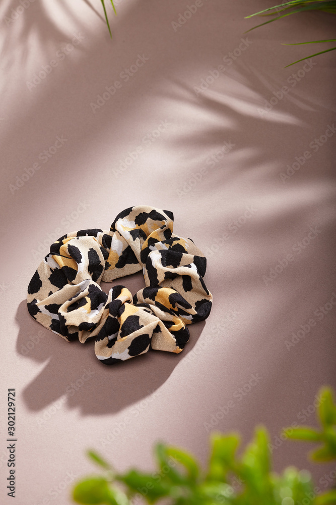 Object photo of a with beige scrunchie with leopard print. The ...
