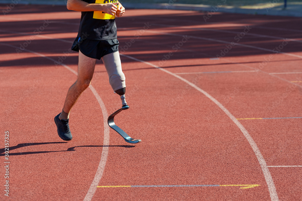Man with prosthetic leg running at a stadium Stock Photo | Adobe Stock