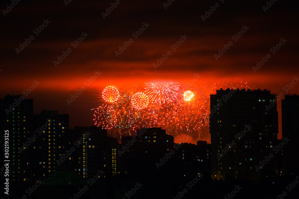 Colorful fireworks over the night city from the height of roofs Stock ...
