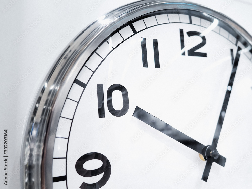 10 o'clock retro clock on white wall. The hands point to 10 o'clock ...