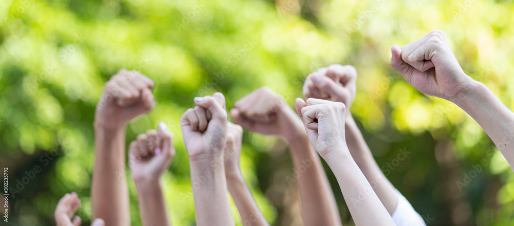 Panoramic group of hands business team raised fist air corporate ...