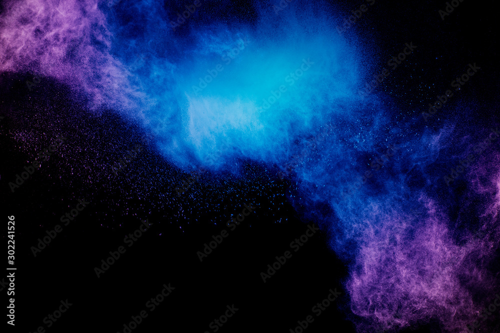 Explosion of pink blue colored powder isolated on black background.Pink ...