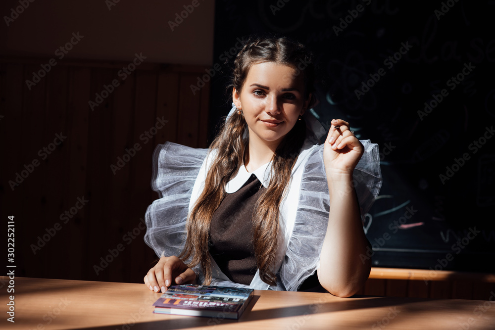 Cute student girl with long hair posing in school uniform near ...