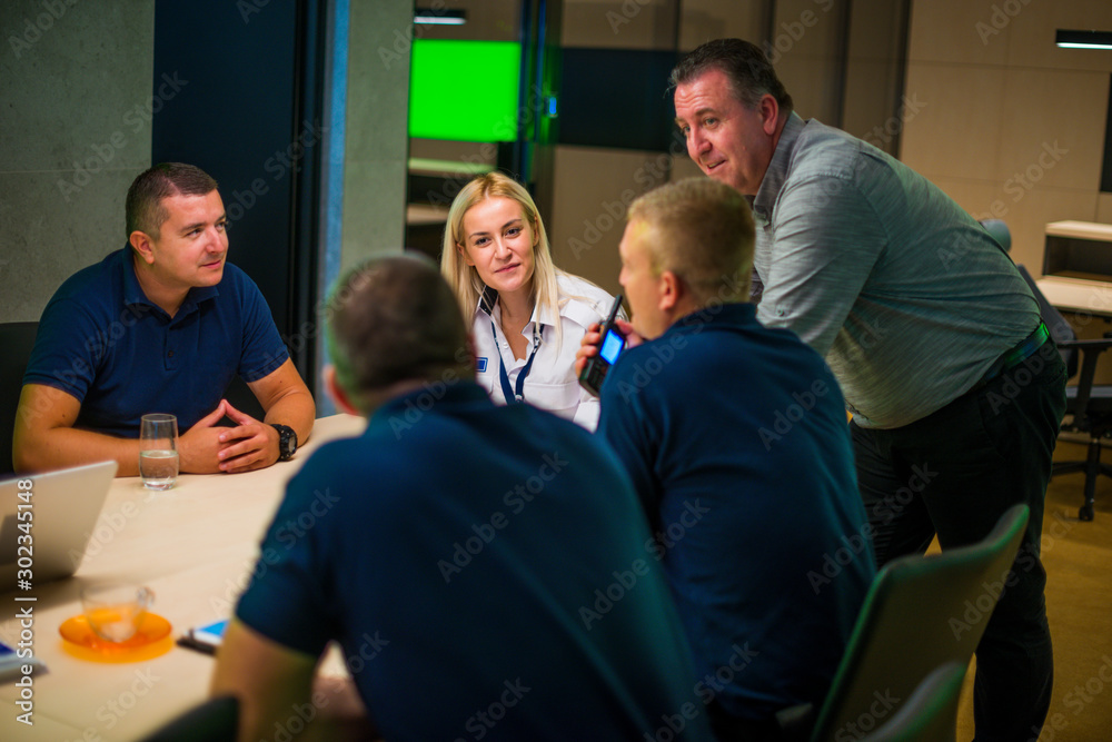 Security guard monitoring modern CCTV cameras in a surveillance room ...
