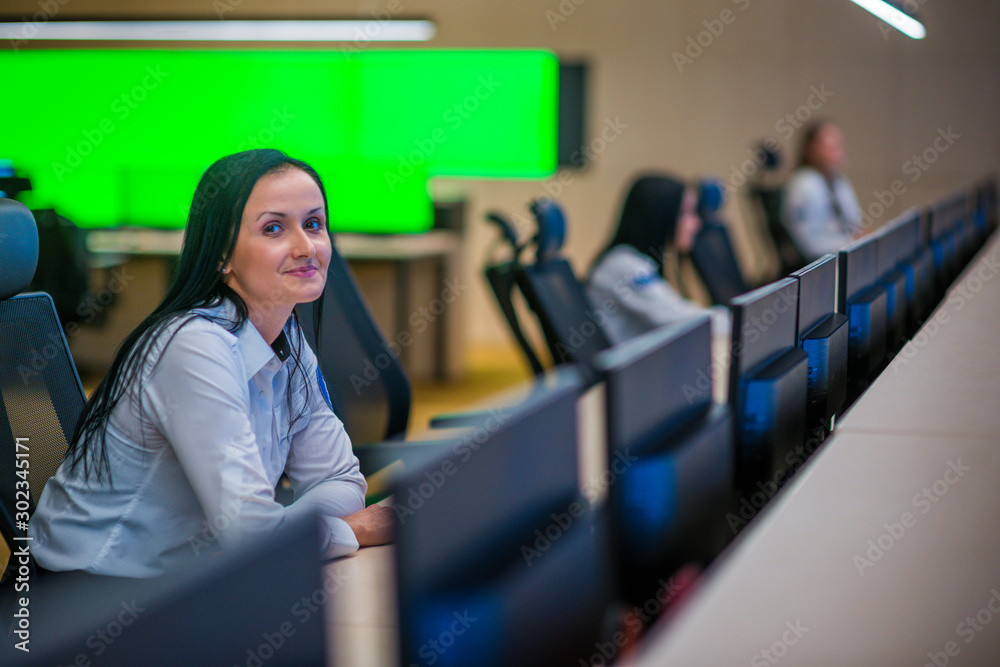 Security guard monitoring modern CCTV cameras in a surveillance room ...