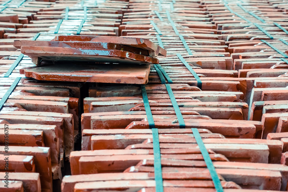 Close up to many pile of roof tiles traditional clay stack for a ...