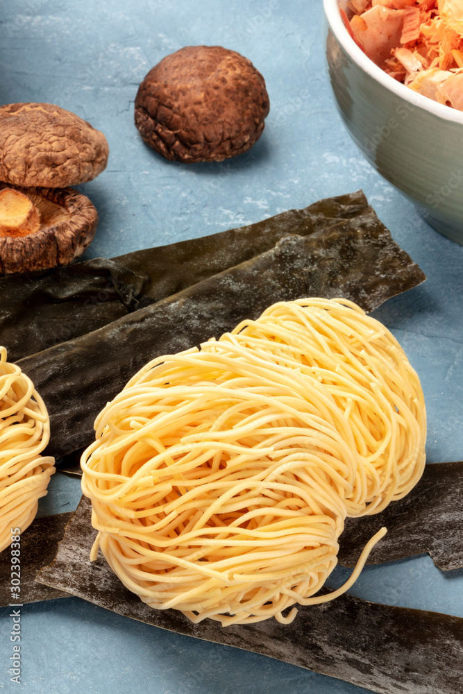 Udon noodles, close-up with dried sea vegetable kelp, shiitake ...