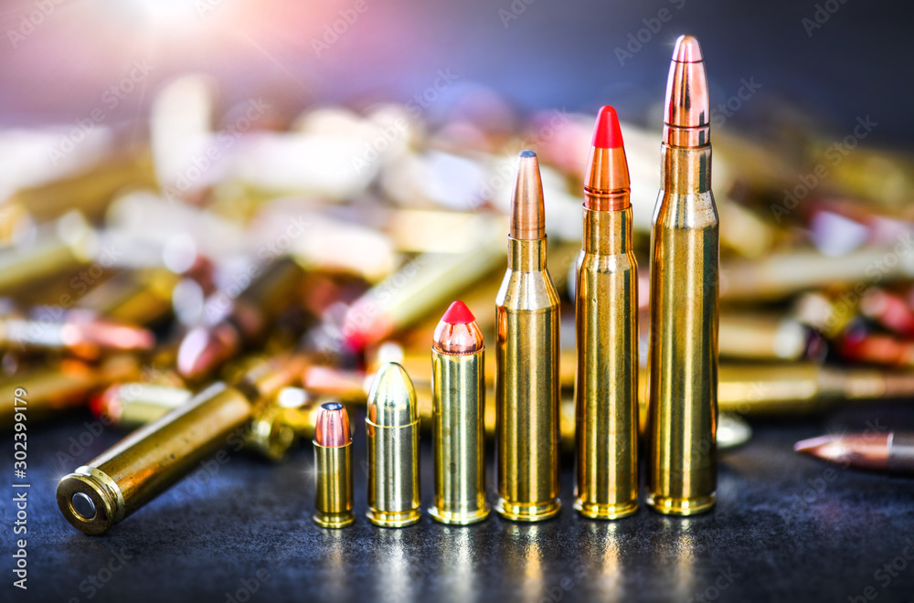 Various kind of bullets or ammo on stone table wide banner. Panorama ...