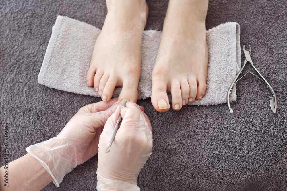 Foot care, female feet during a pedicure at a beauty salon The ...