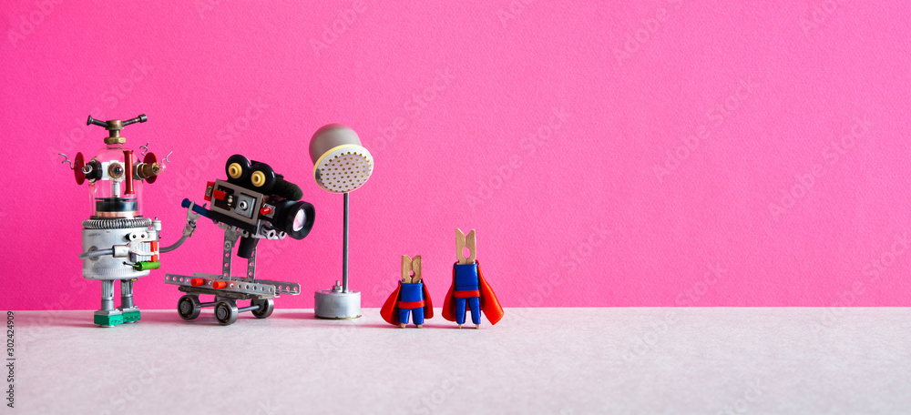 Comical art. Toy robot cameraman makes a movie about super heroes ...