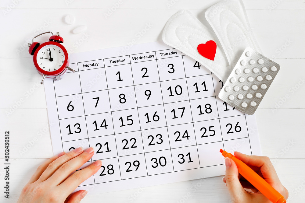 Menstruation calendar with pads, alarm clock, hormonal contraceptive ...