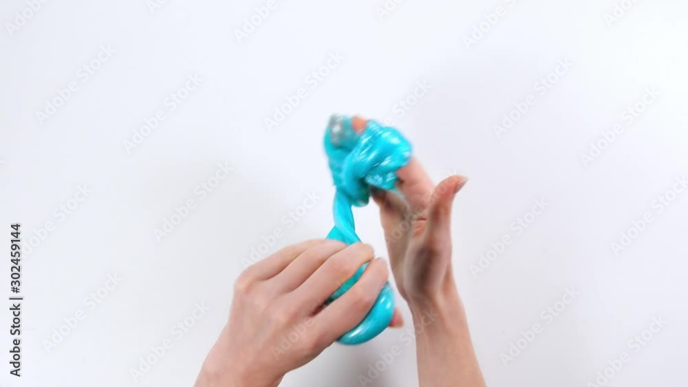 Playing with slime, stretching the gooey substance for fun and stress ...