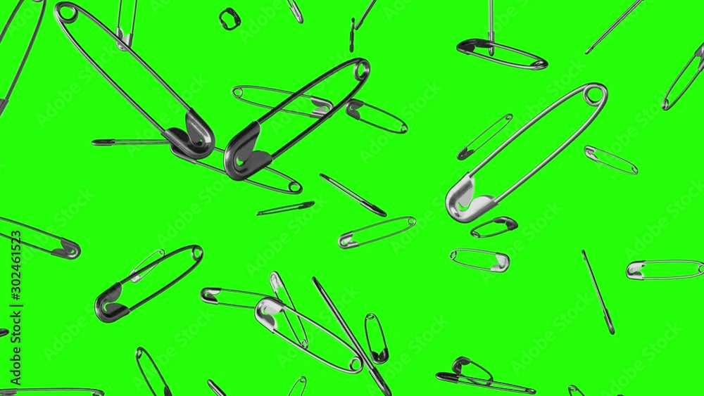 Rain of a pile of closed metal safety pins falling on green screen ...