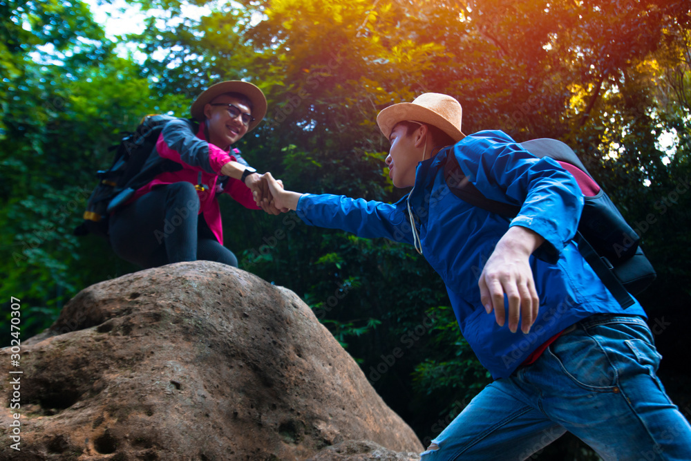 The climbers on the cliff pulled their hands together, two people ...