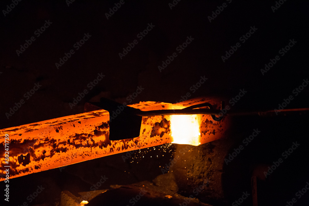 Gas cutting of the hot metal in steel plant at Demra, Dhaka, Bangladesh ...