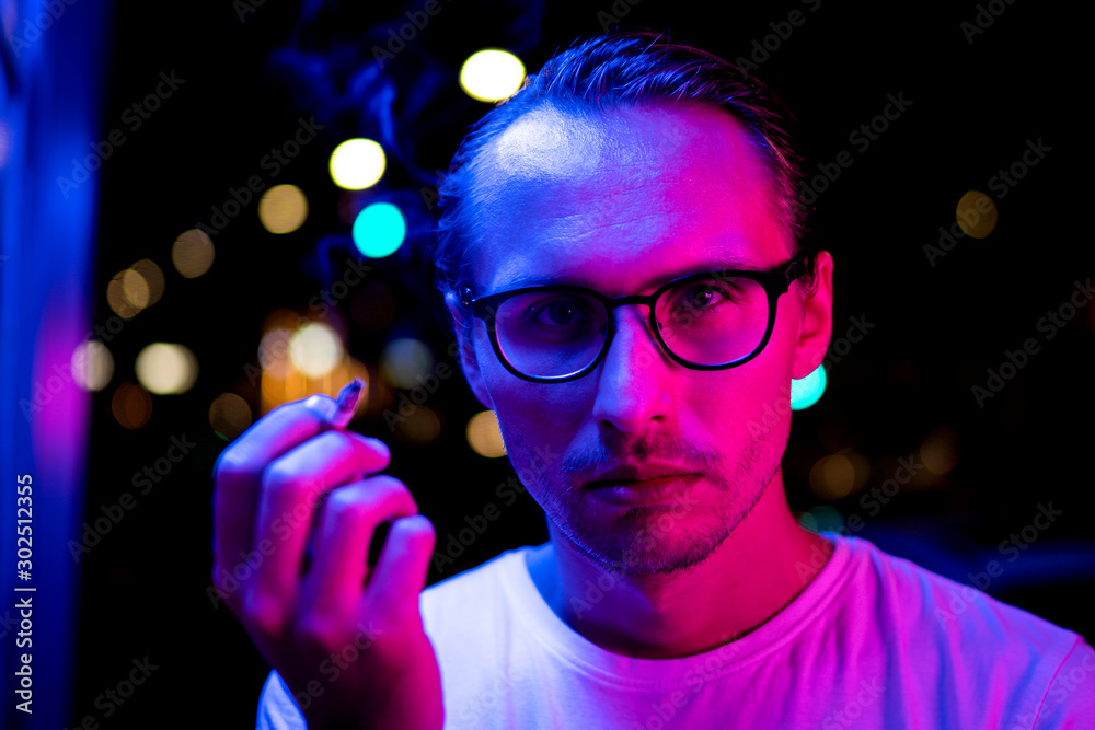 Vintage, red and blue portrait of a young man smoking a cigarette ...