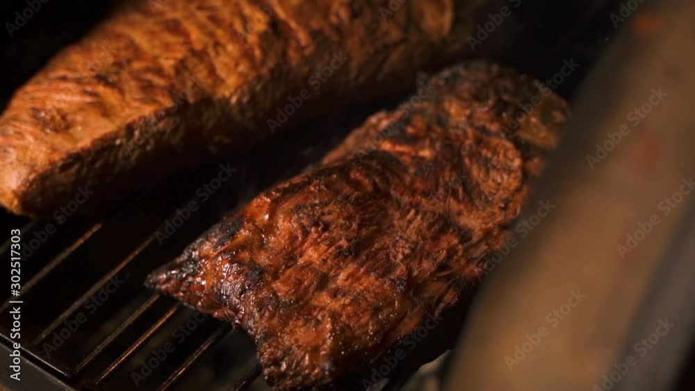 Video „Chef puts a ready-made piece of meat, beef or pork on the grill ...