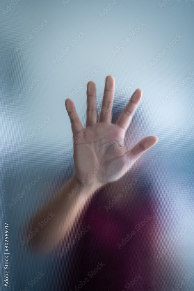 Blurry woman hand behind frosted glass metaphor panic and negative dark ...