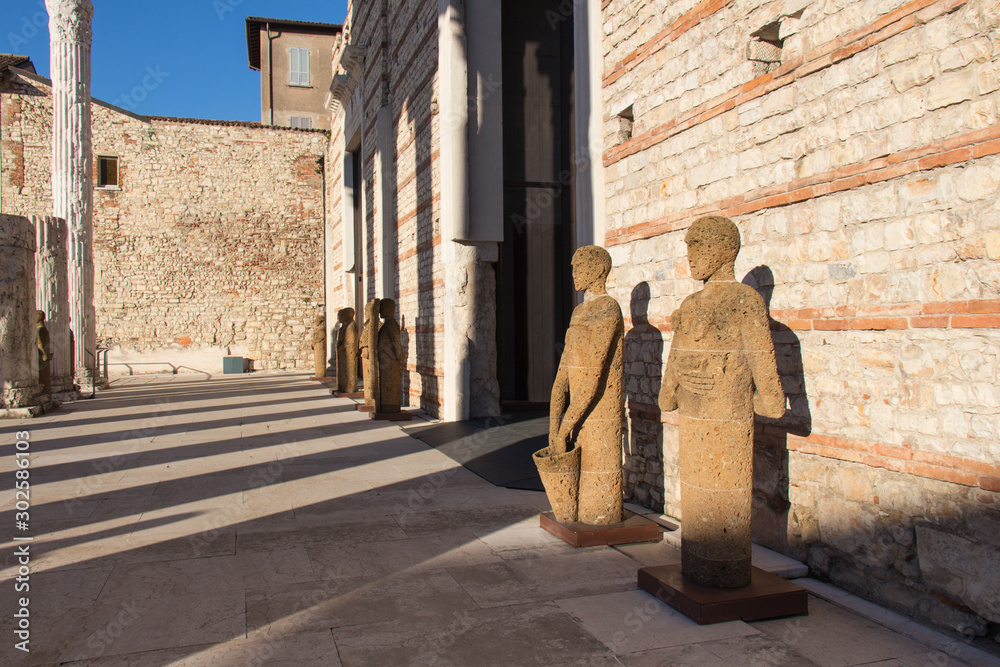 Tuff rock sculptures by Mimmo Paladino in the ancient Roman temple of ...