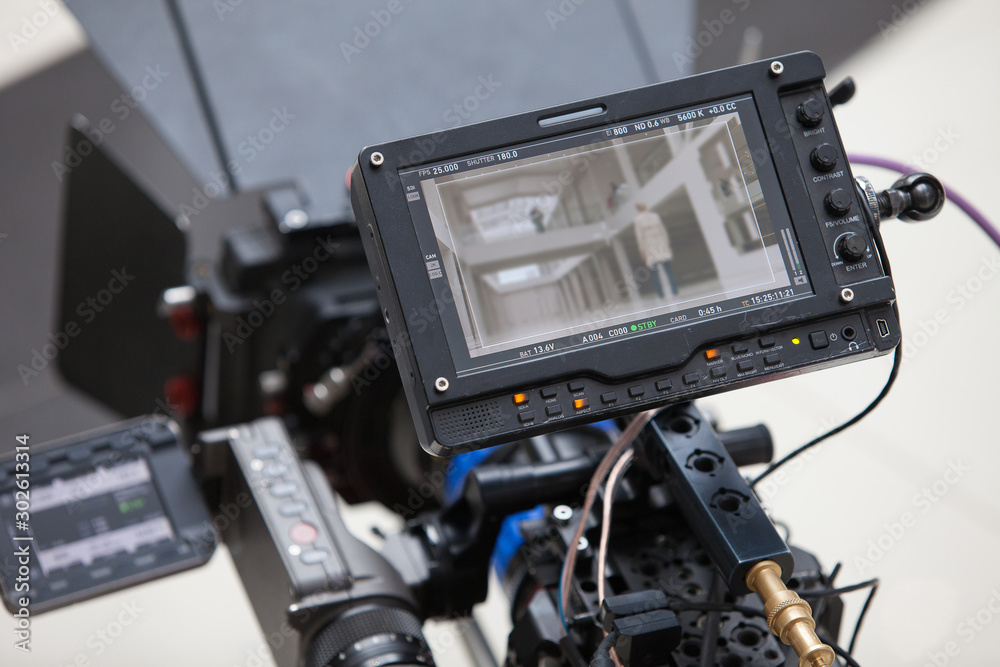 Video cameras on the set, backstage of the movie scene, operator hands ...