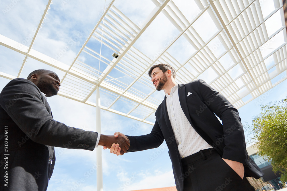 Two business men shake hands Stock Photo | Adobe Stock