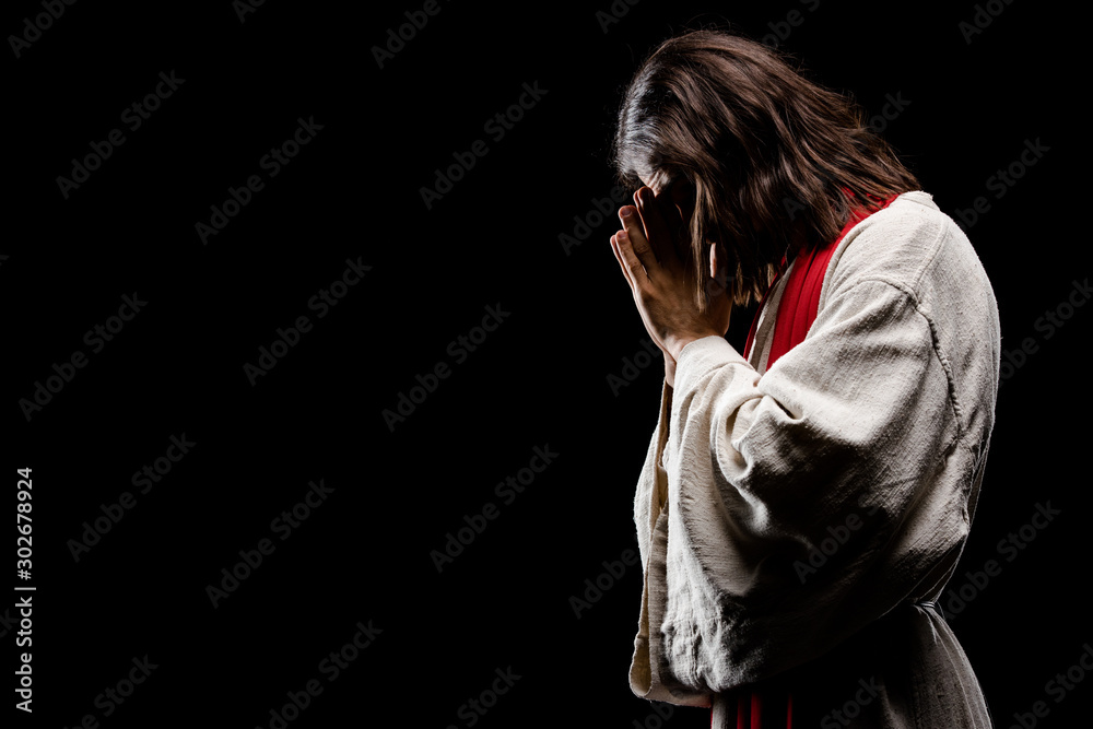 religious man covering face while praying isolated on black Stock Photo ...