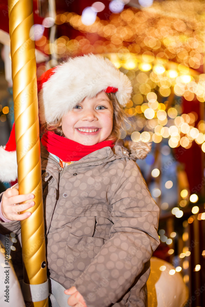 pretty young girl taking a ride in a carousel at christmas Stock Photo ...