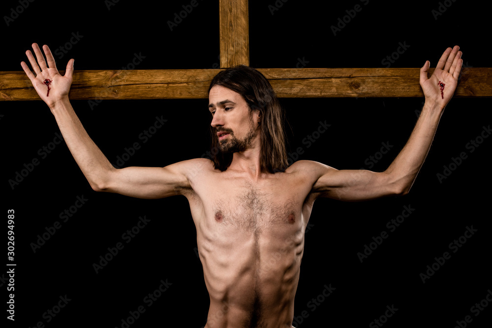 shirtless man crucified on wooden cross isolated on black Stock Photo ...