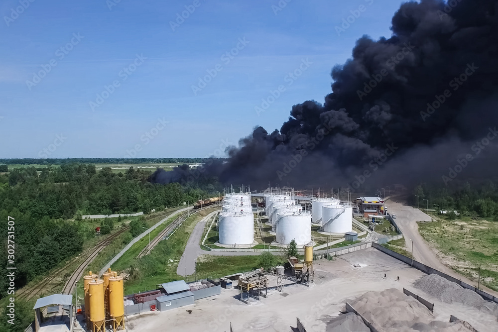 Oil storage fire. The tank farm is burning, black smoke is combu Stock ...