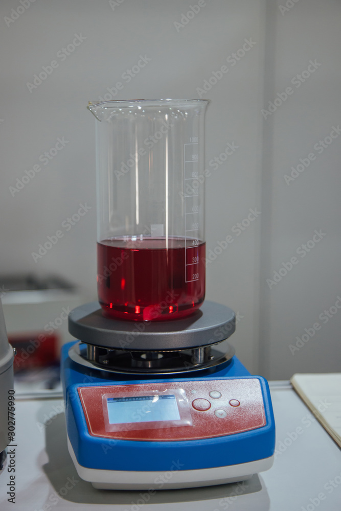Beaker with chemical solution on laboratory scales Stock Photo | Adobe ...