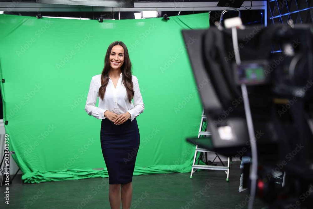 Presenter and video camera operator working in studio. News ...