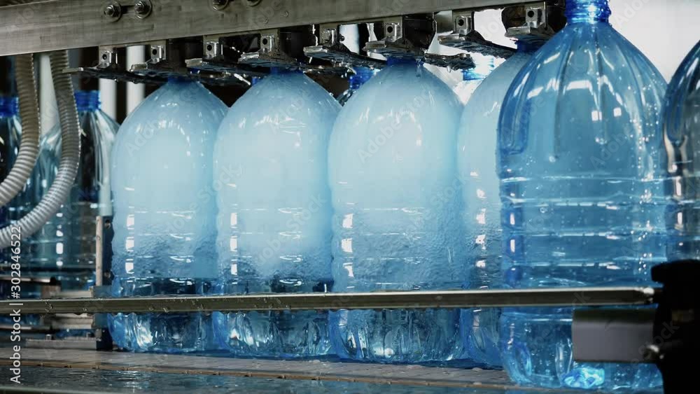 Factory of production and bottling clean water on automatic conveyor ...