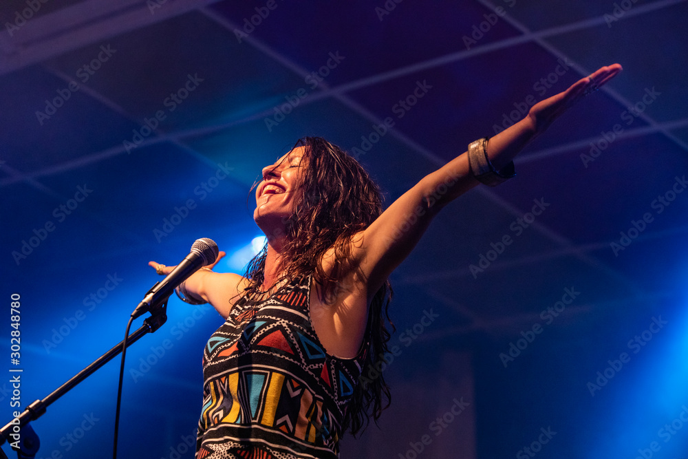 Photo & Art Print a female musician is viewed from a low angle as she ...