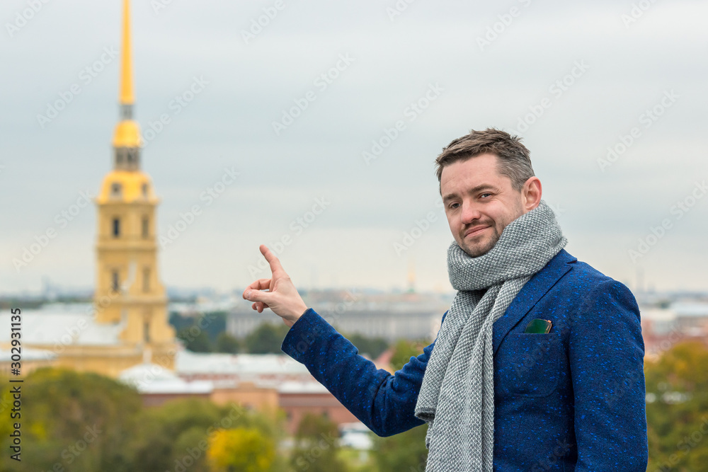 Stylish young man points with an index finger to the Peter and Paul ...