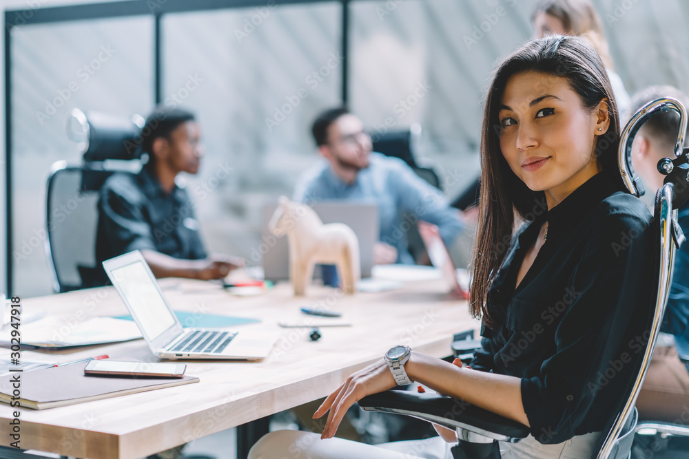 Portrait of Asian prosperous employee sitting front laptop computer at ...