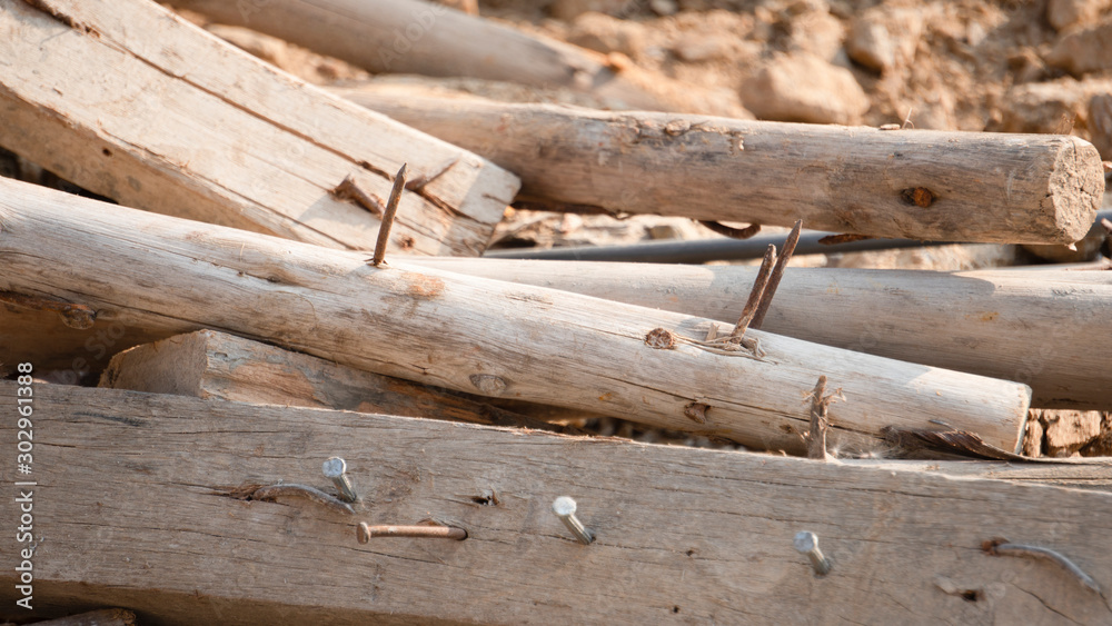 Dangerous sharp tip of rusty nail on hard wood in construction area ...