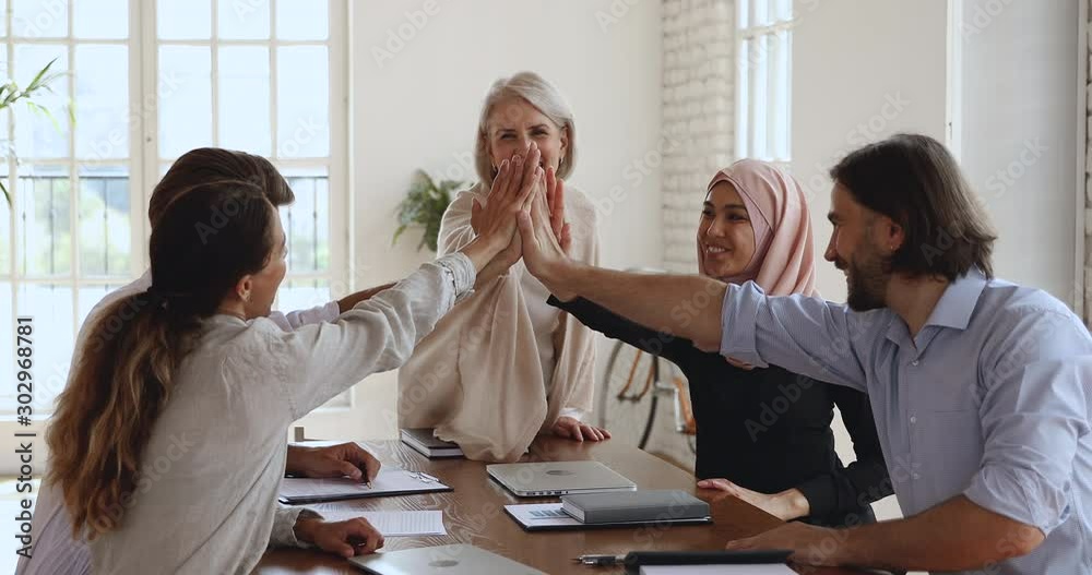 Mature leader unite happy multicultural team give high five together ...