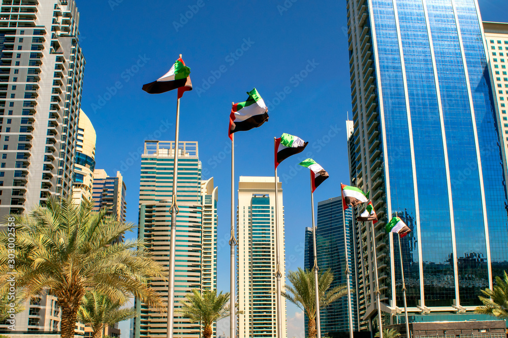 View of Dubai buildings with UAE flags. United Arab Emirates flags ...