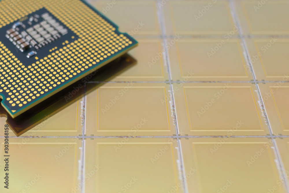 Computer CPU processor chip on yellow surface of slicion wafer chip ...
