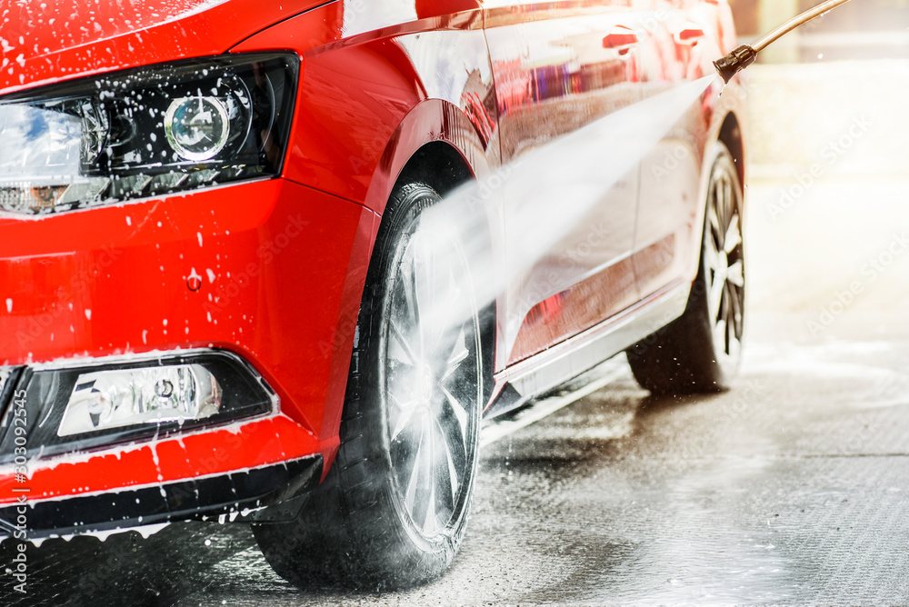 Car washing concept. Cleaning vehicle wheel or rim using high pressure ...