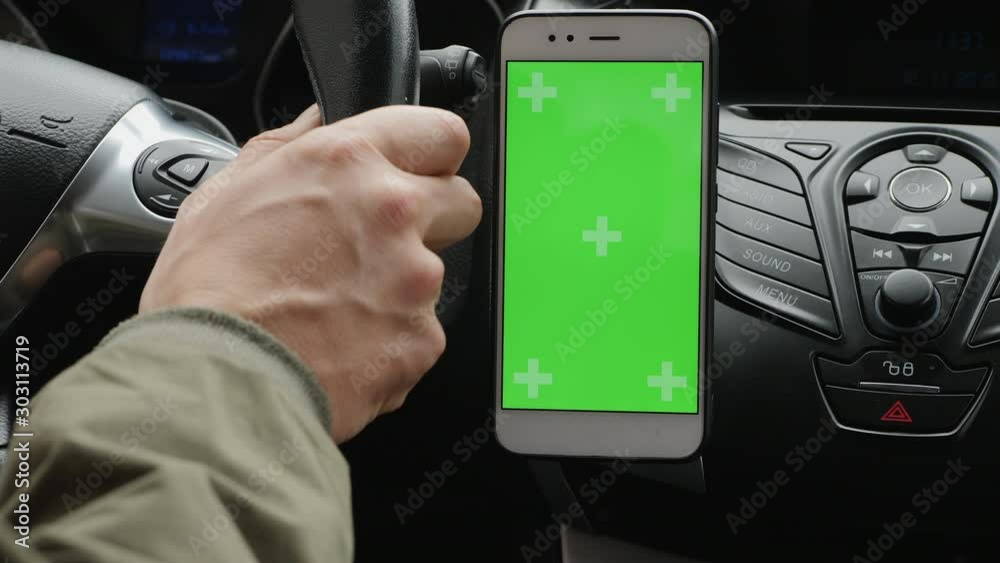 Close-up hand of driver is driving a car while holding a steering wheel ...