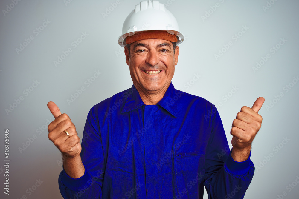 Handsome middle age worker man wearing uniform and helmet over isolated ...