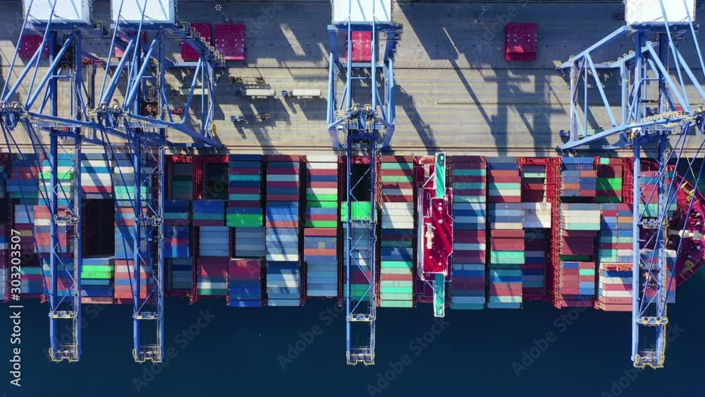 Aerial top down pan video of industrial container loading and unloading ...