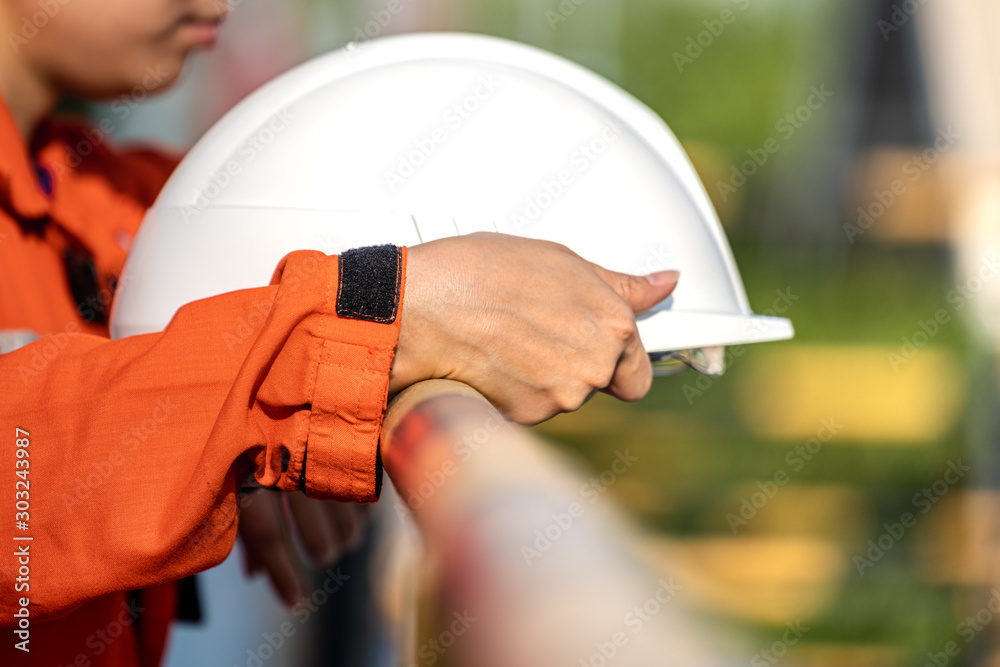 Oil field operator, technician or worker is standing close to the walk ...