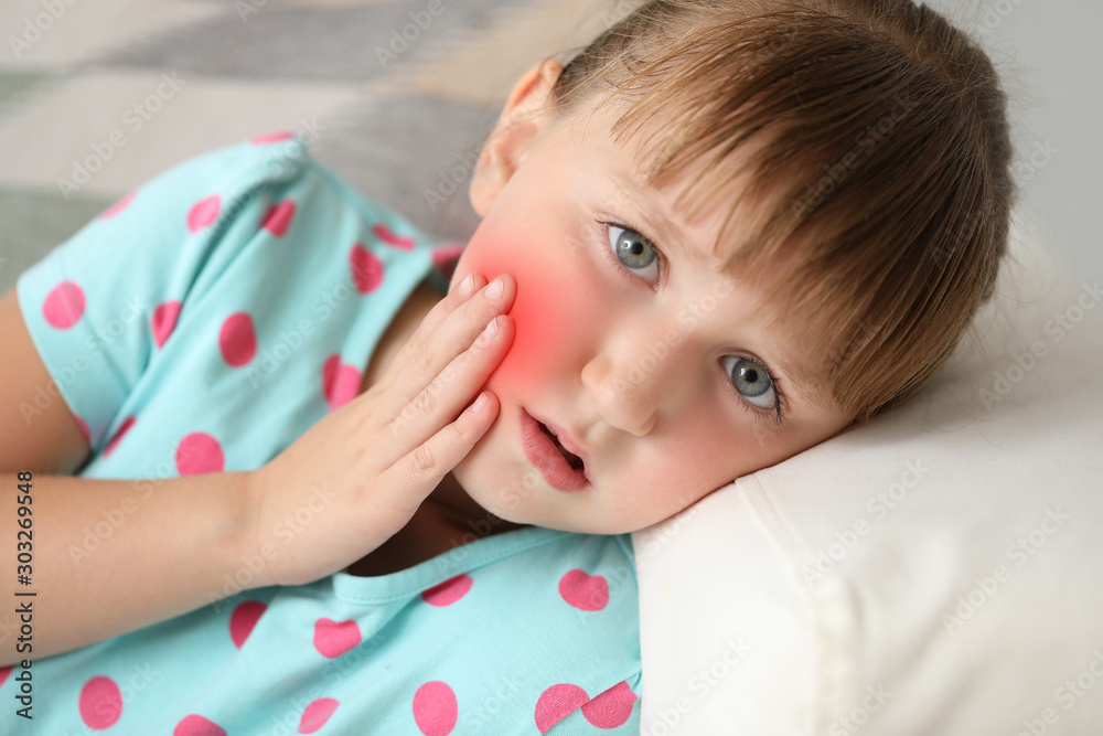 Little girl suffering from toothache at home Stock Photo | Adobe Stock