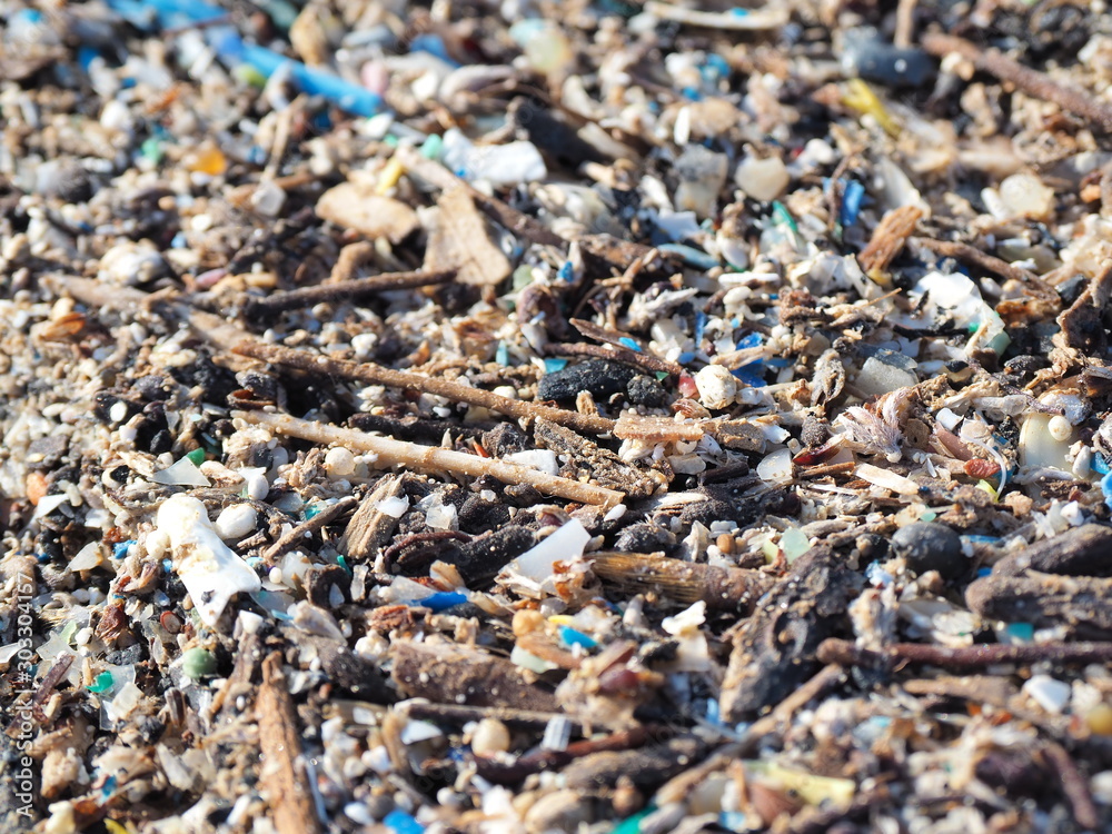 Environmental pollution. Sand beaches polluted with pieces of plastic ...