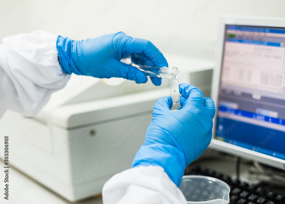 The analyst is testing sample by spectrometer in the laboratory, filled ...