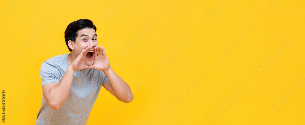 Young happy asian man yelling with hands cup around mouth Stock Photo ...