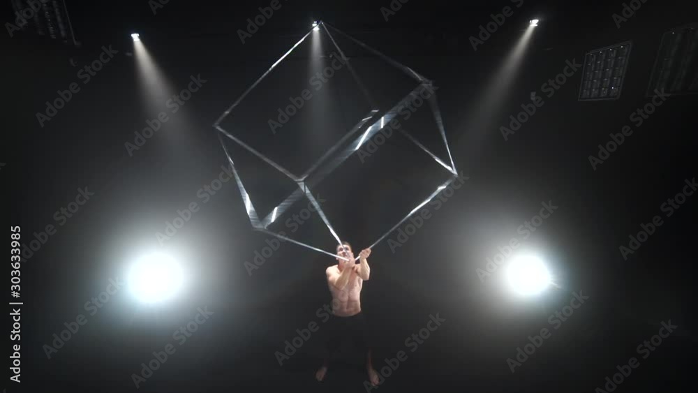 circus male muscular performer making tricks with juggling cube props ...
